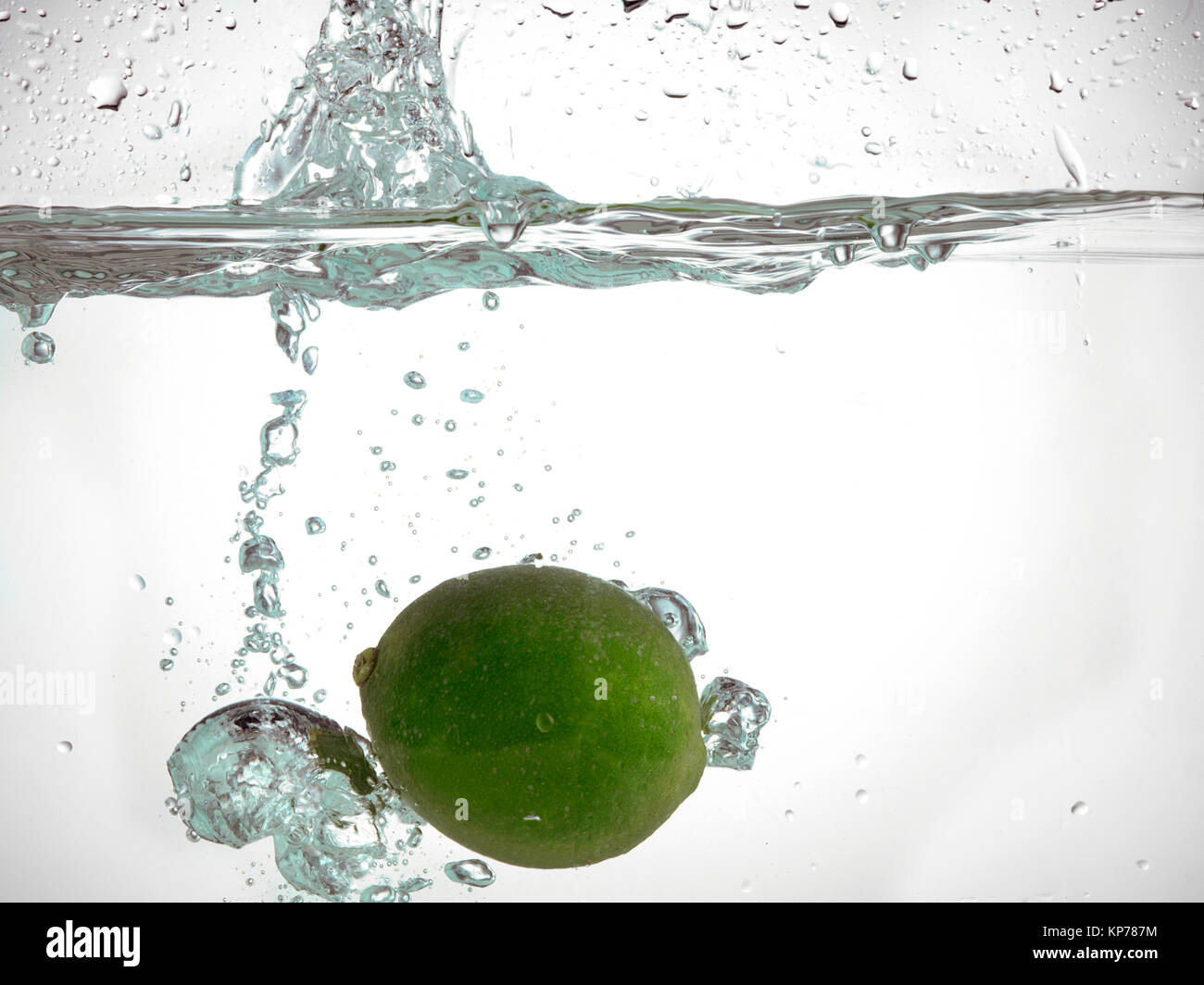 lime falling in clear water Stock Photo - Alamy