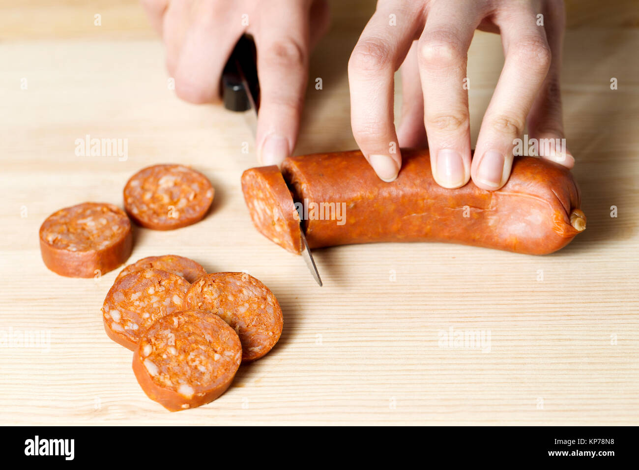 human hand cutting a sausage Stock Photo - Alamy