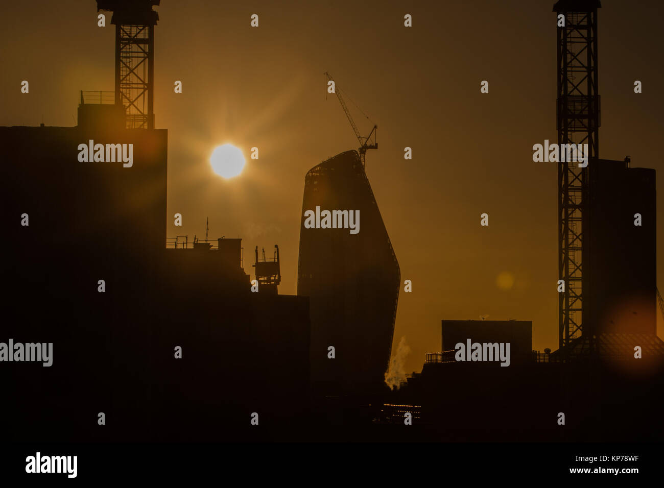The sun shines across the dome of St Pauls and the building works of ...