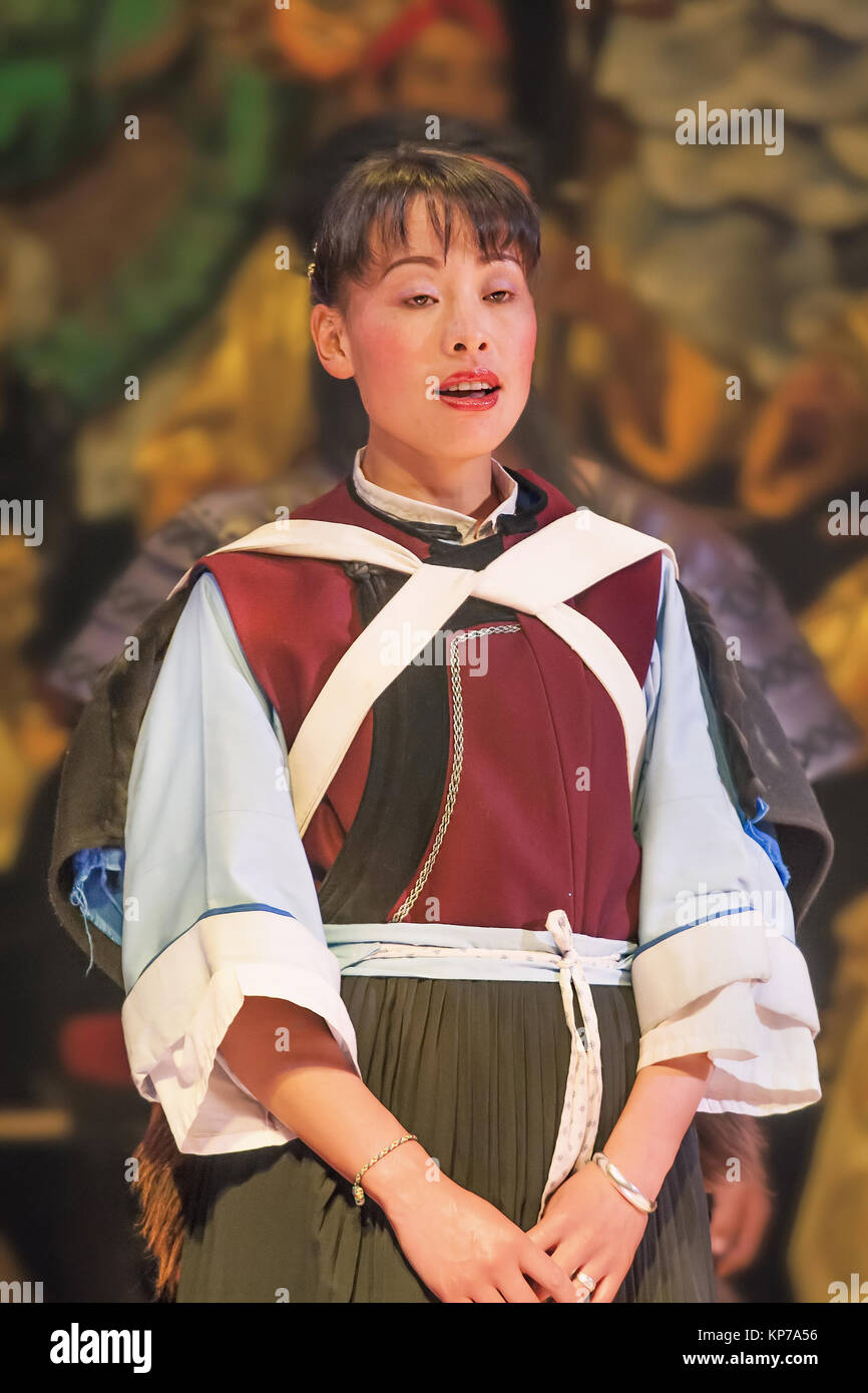 LIJIANG-CHINA-SEPT. 23, 2006. A Naxi woman performs in a theater. Naxi ...