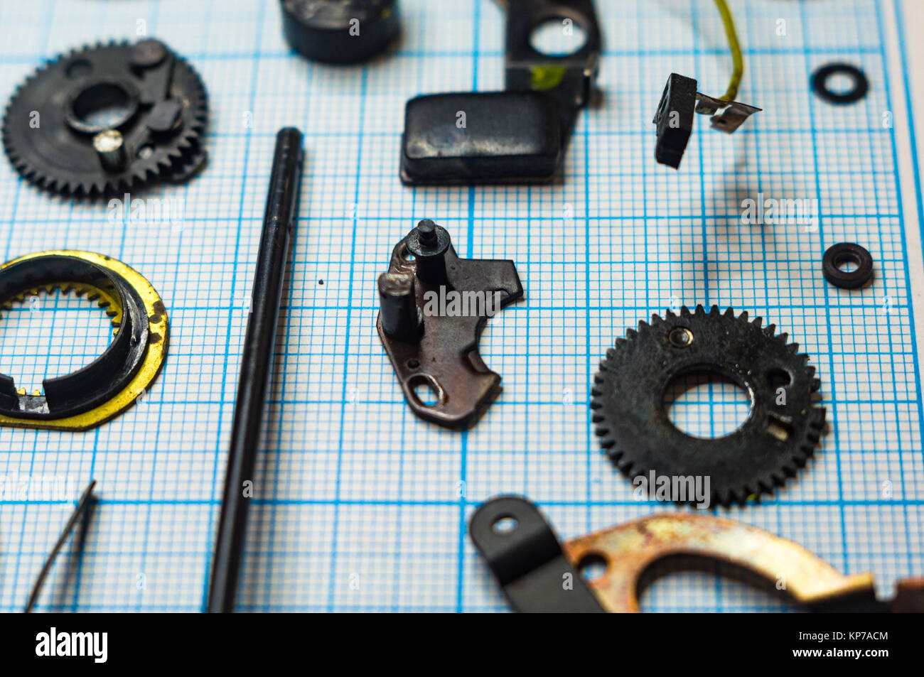 parts are completely disassembled old retro film SLR camera on graph ...