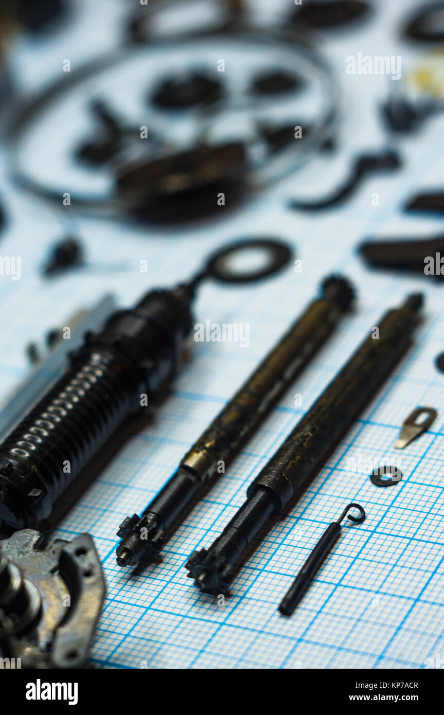 parts are completely disassembled old retro film SLR camera on graph ...
