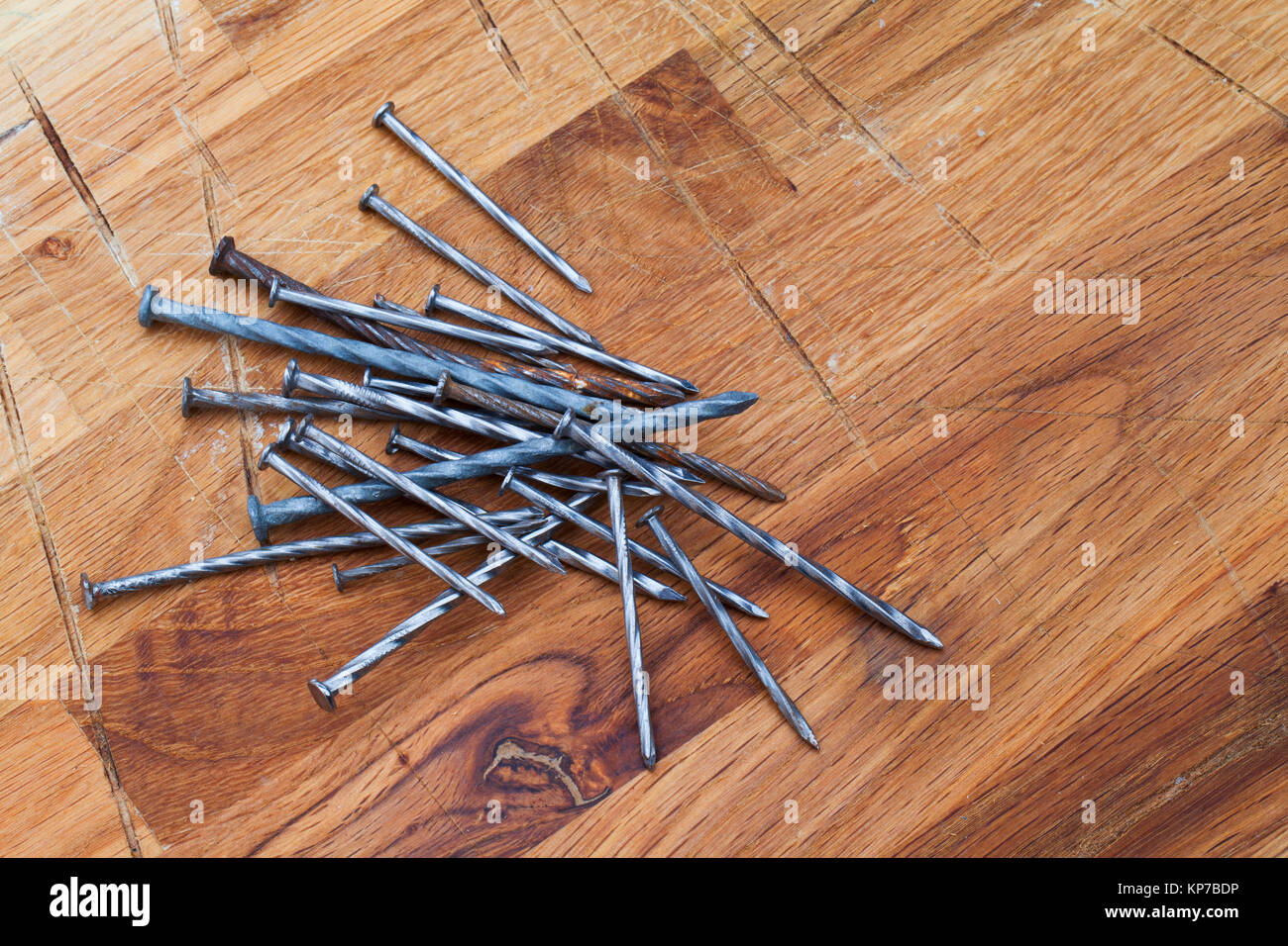 nails on wood table Stock Photo - Alamy