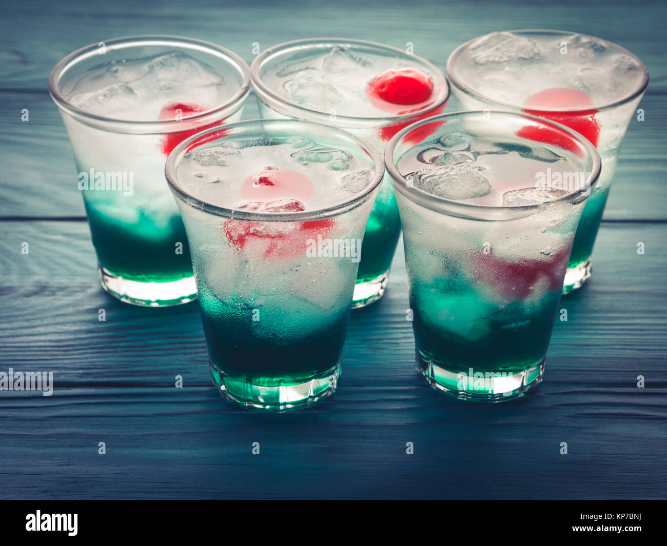 Short alcohol green drinks with cherry and crushed ice. Christmas Saint ...