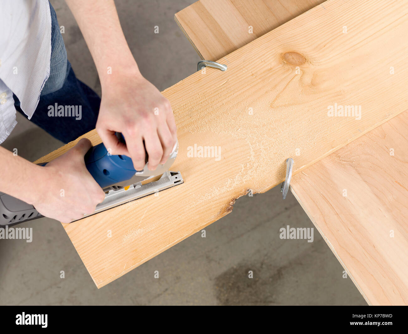 overhead image of a man cutting sheet of a wooden plank Stock Photo - Alamy