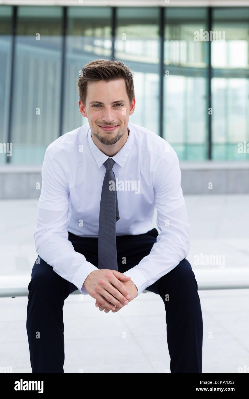 Businessman sitting on the blench Stock Photo - Alamy