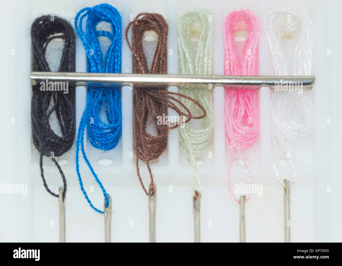 Colorful thread and needle macro with white background Stock Photo - Alamy
