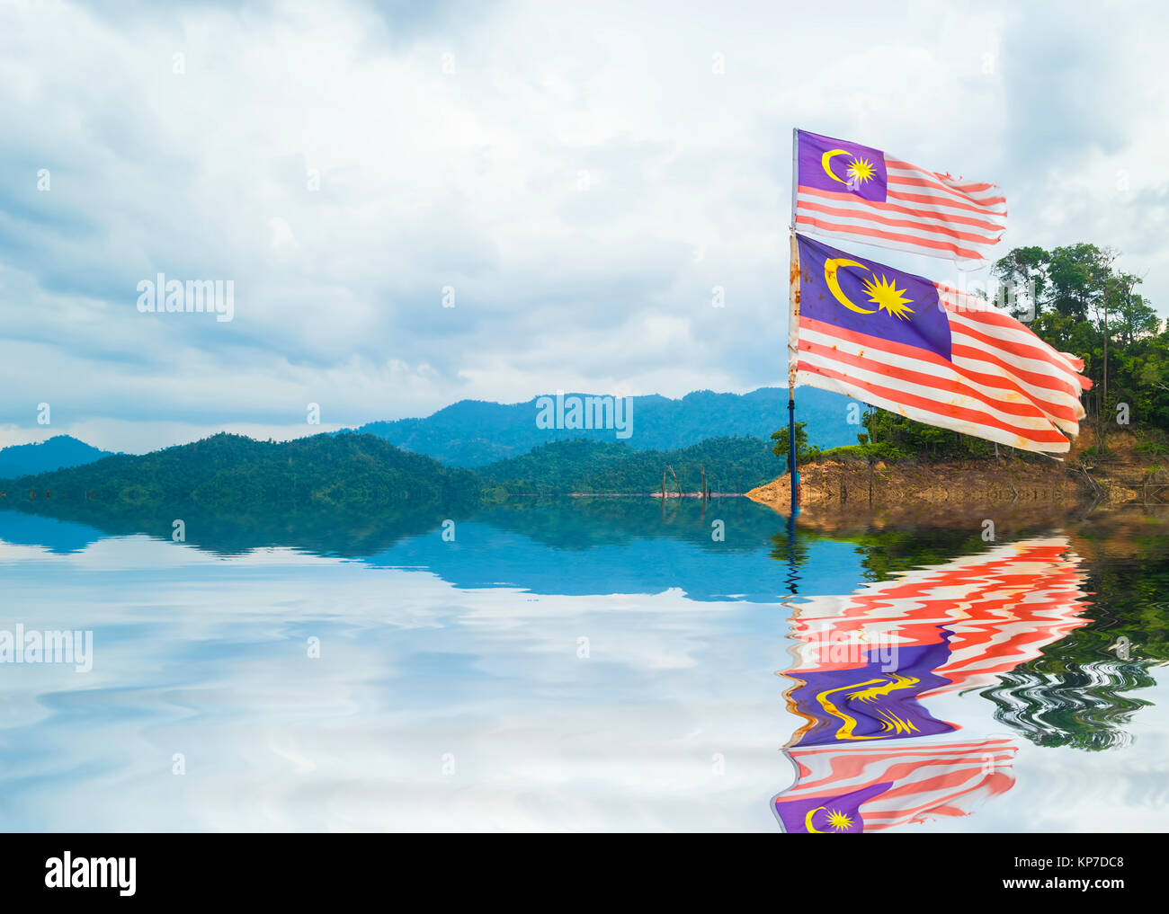 Malaysia flag with tropical island and cloudy skies Stock Photo - Alamy
