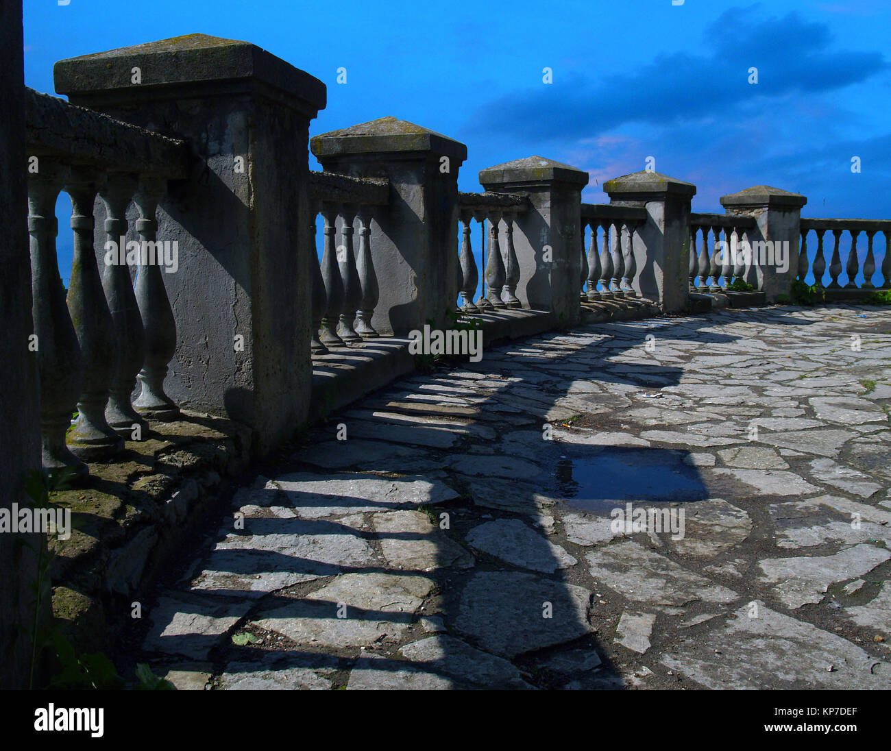 Old stone balustrade, a fence on a background of a bright blue sky ...