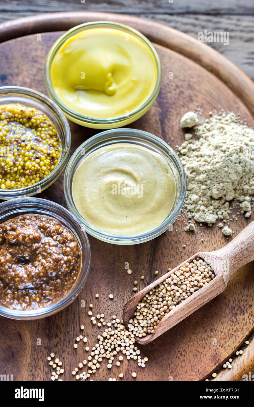 Different kinds of mustard on the wooden background Stock Photo - Alamy