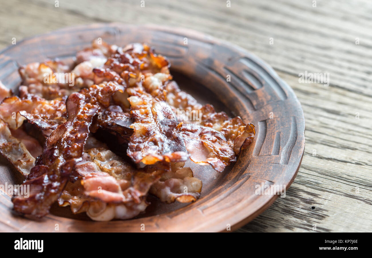 Fried bacon strips on the plate Stock Photo - Alamy