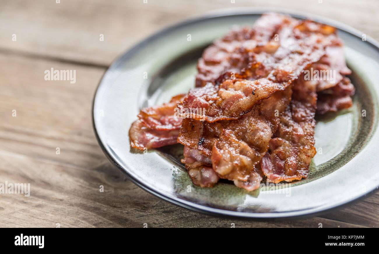 Stack of fried bacon strips on the plate Stock Photo - Alamy
