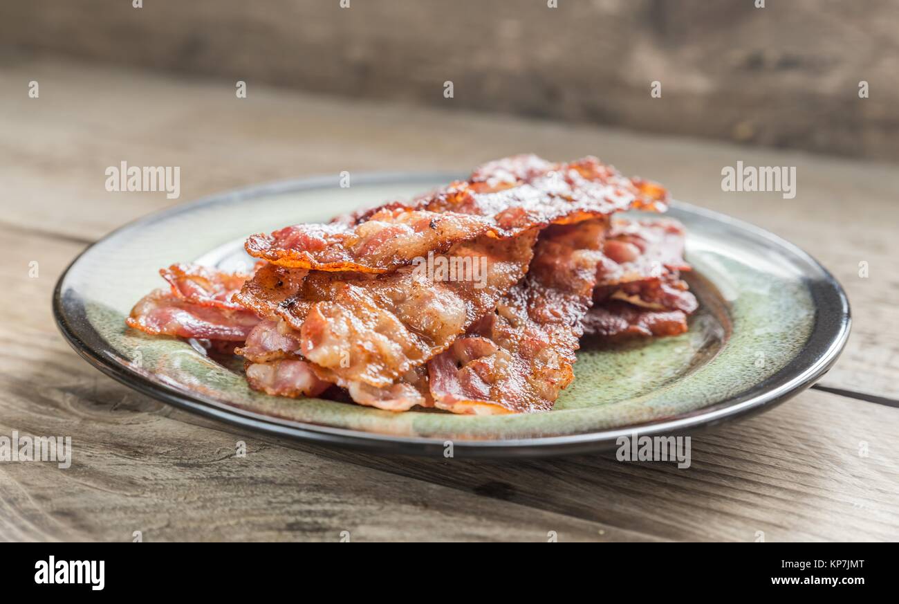 Stack of fried bacon strips on the plate Stock Photo - Alamy