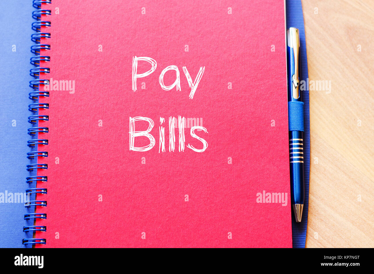 Pay bills write on notebook Stock Photo - Alamy