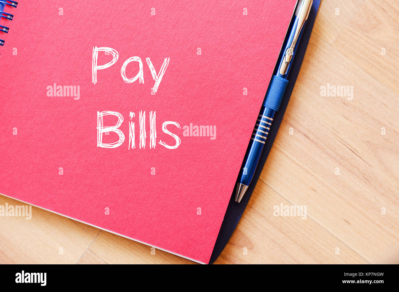 Pay bills write on notebook Stock Photo - Alamy