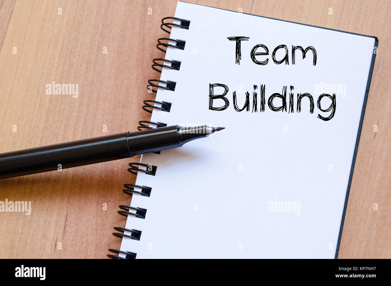 Team building write on notebook Stock Photo - Alamy