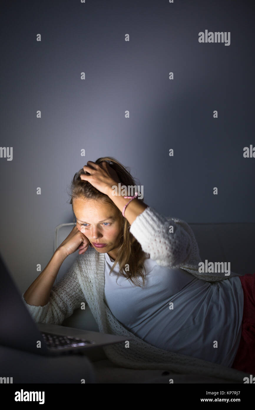 Very tired young woman, burning the midnigh oil Stock Photo - Alamy