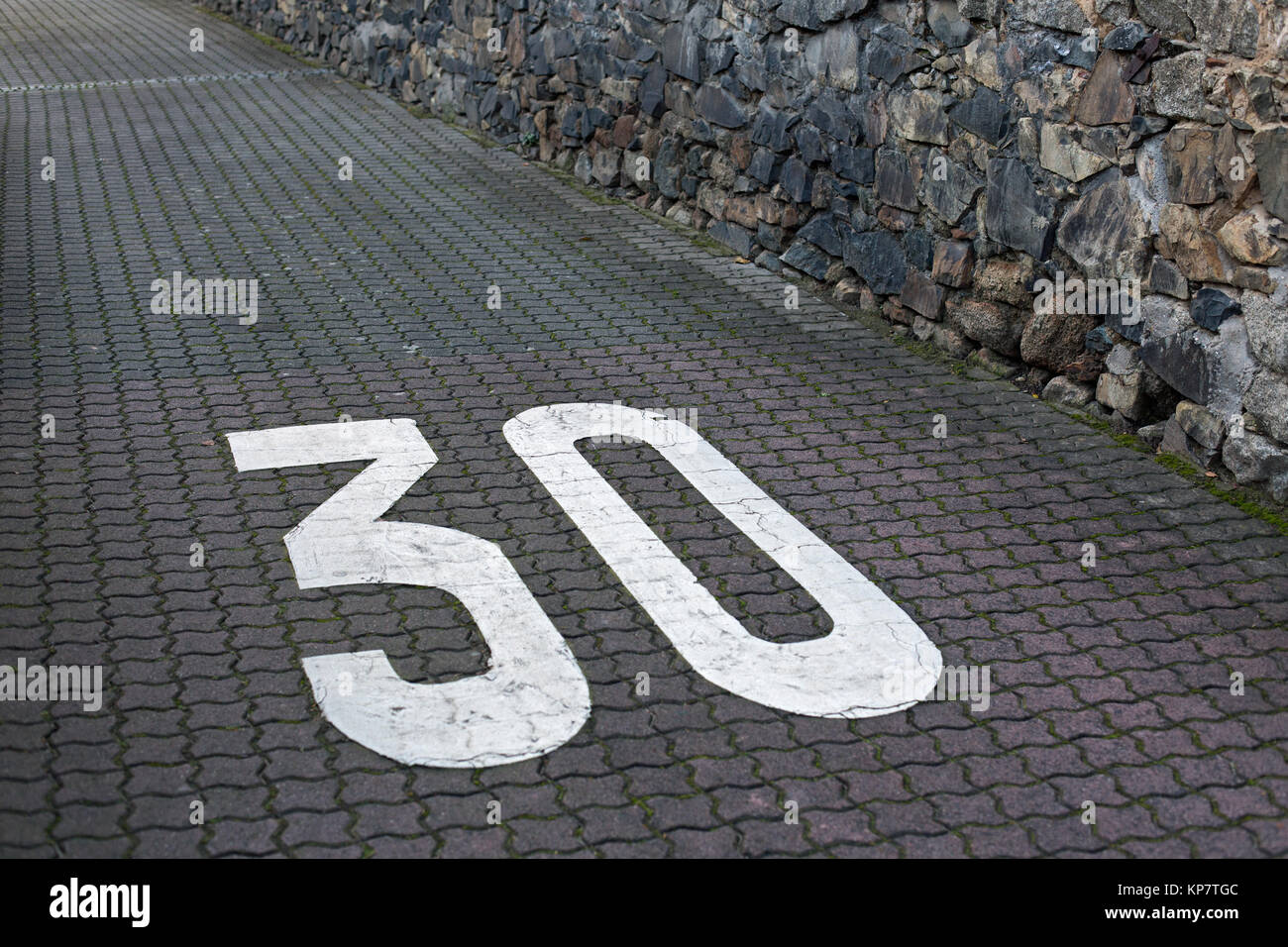 Signs for Tempo 30 Zone on cobblestones Stock Photo - Alamy