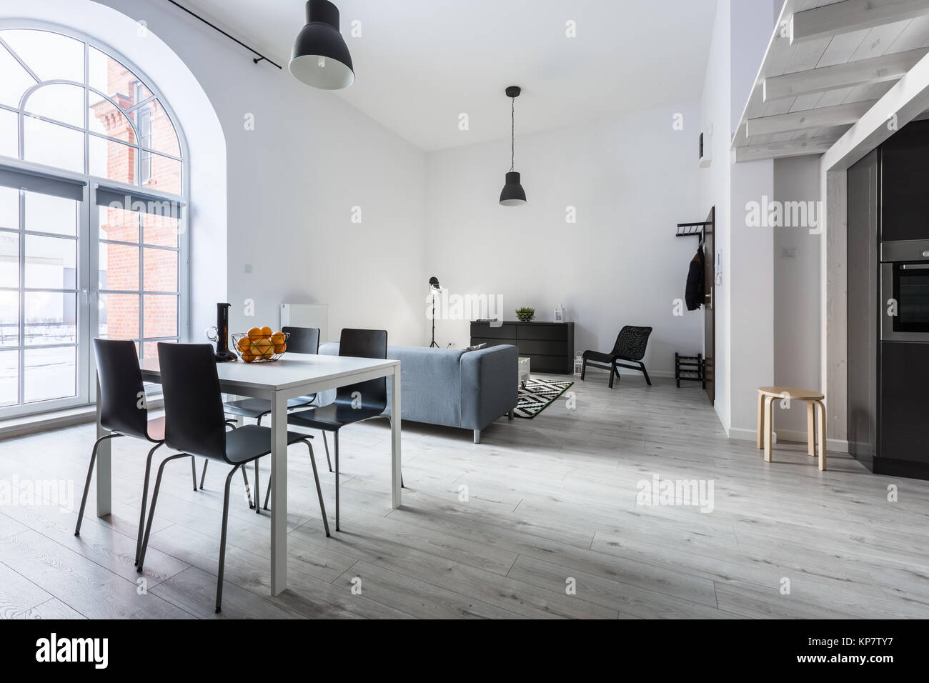 Big half round window in open space loft apartment Stock Photo - Alamy