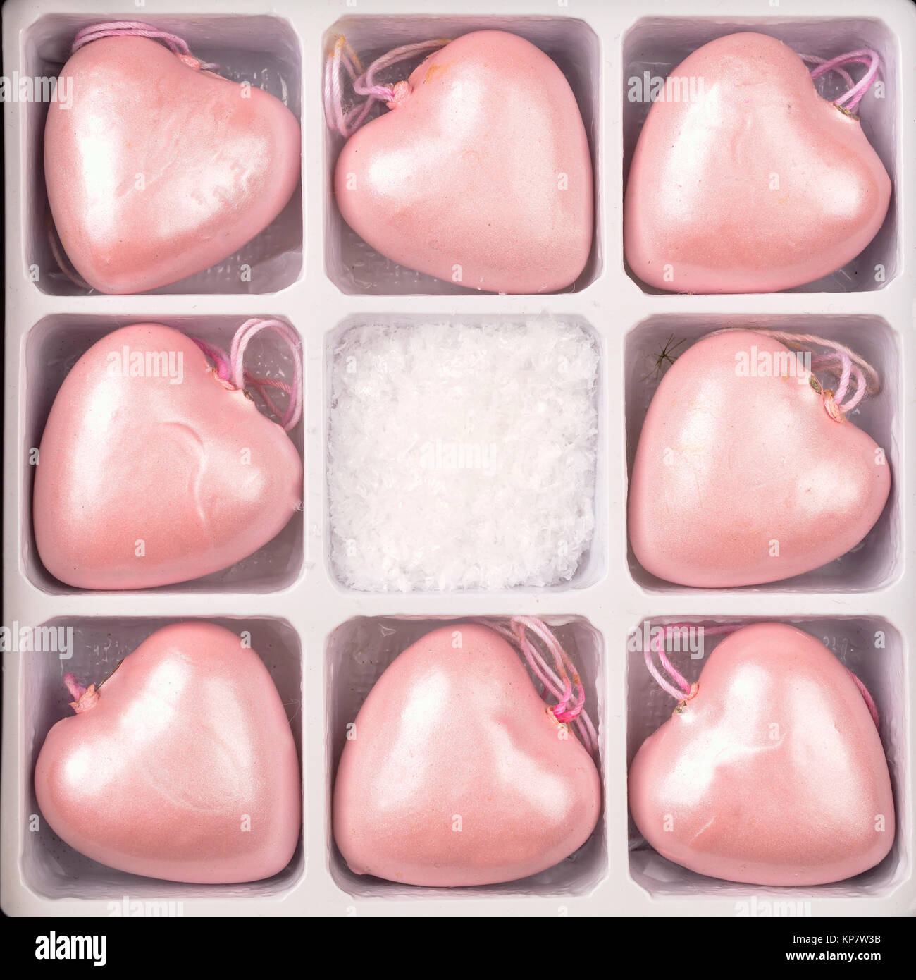 Pink heart shapes in a box with snow Stock Photo - Alamy