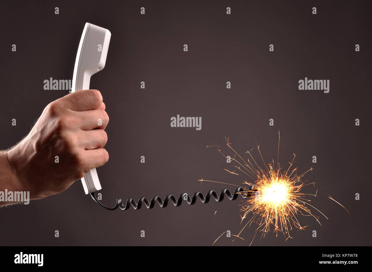 Male hand with a telephone and a burning cable like a fuse Stock Photo ...