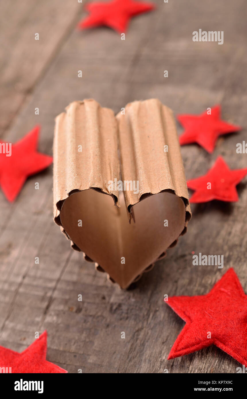 Love concept background with a heart shaped piece of cardboard on a ...