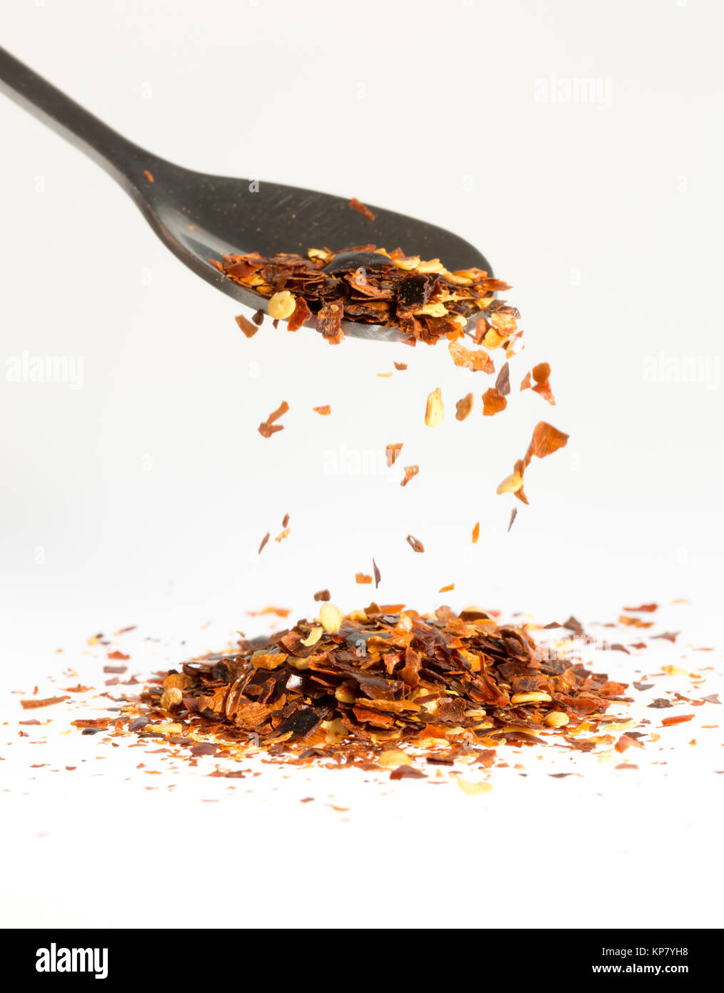 Dried Chili Pepper Falling from Tablespoon Stock Photo - Alamy