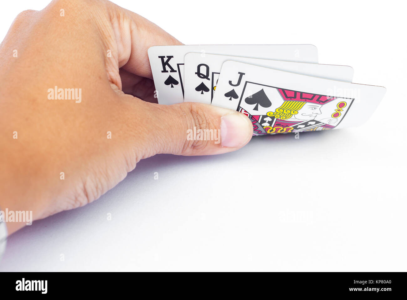 Playing cards in hand isolated on white background Stock Photo - Alamy