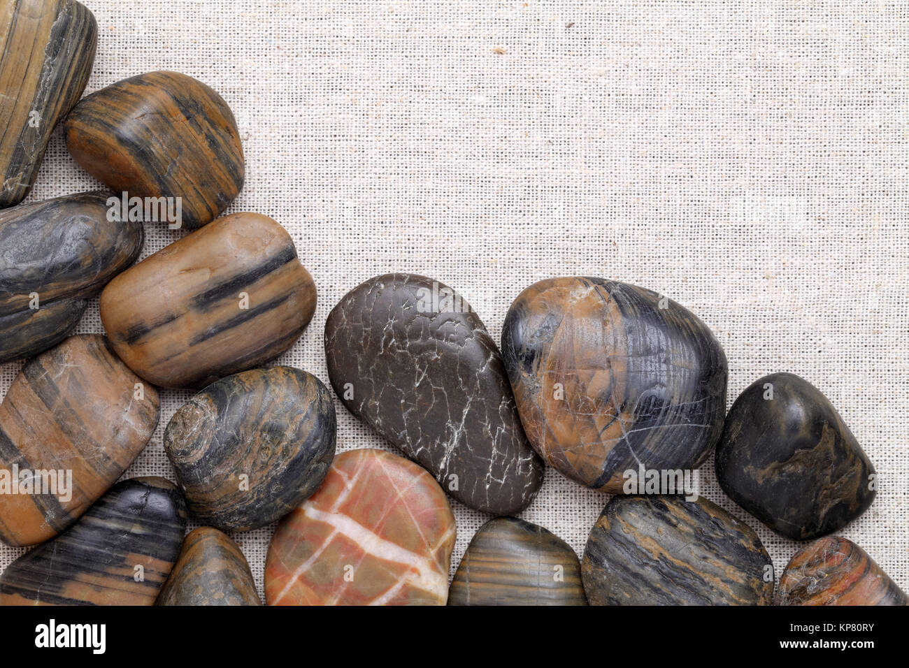 small granite stone on burlap background Stock Photo - Alamy