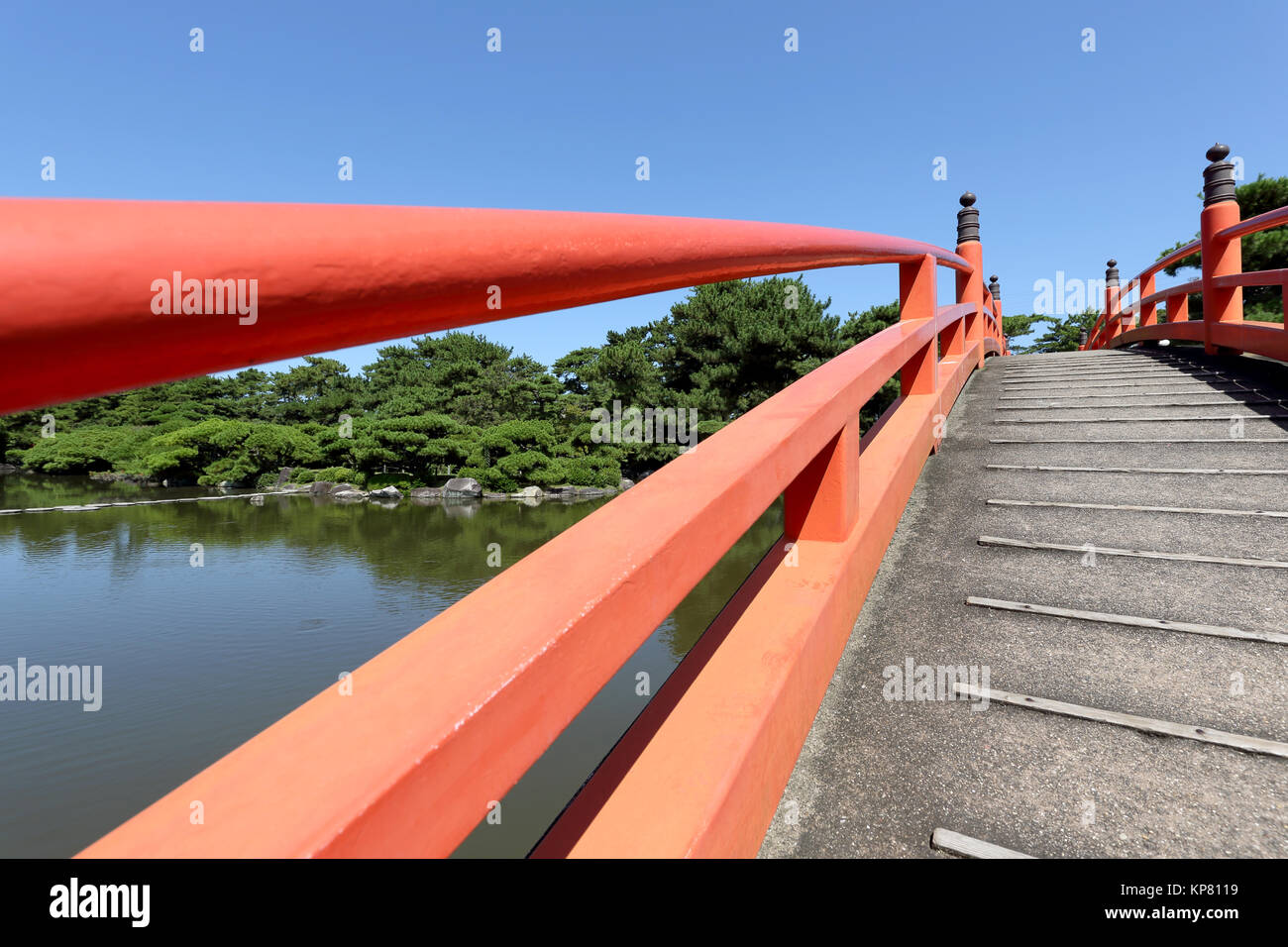View of red wooden bridge in the Japanese park Stock Photo - Alamy