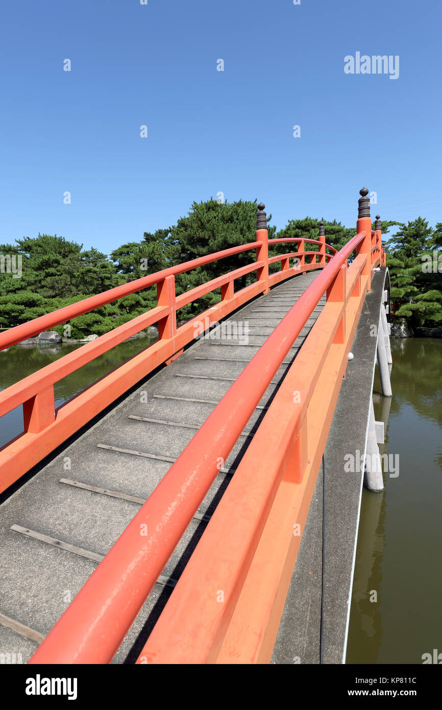 Red wooden bridge in the Japanese park Stock Photo - Alamy