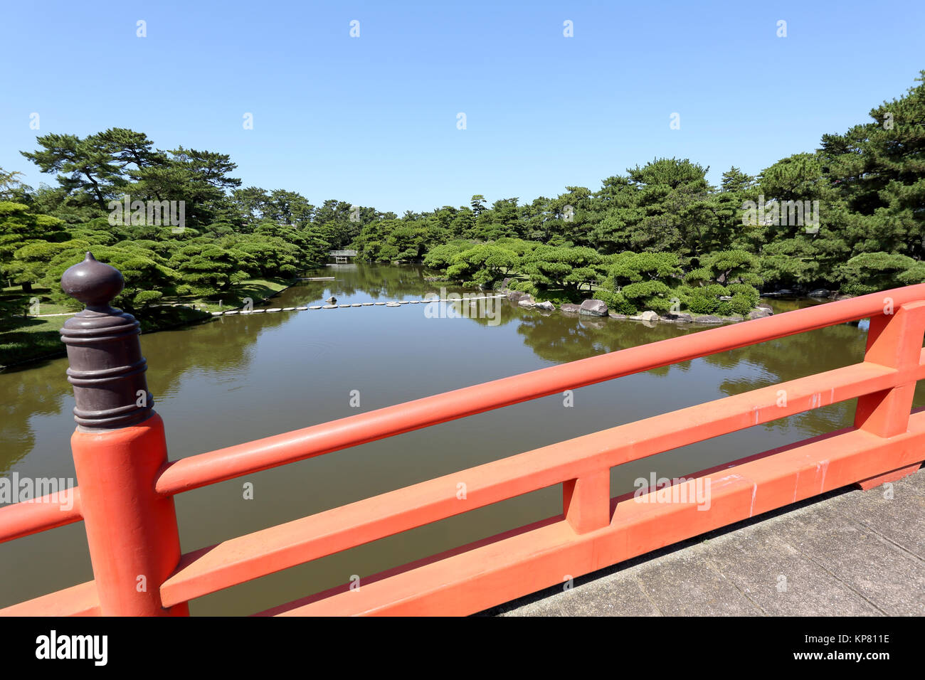 Japanese garden with red wooden bridge Stock Photo - Alamy