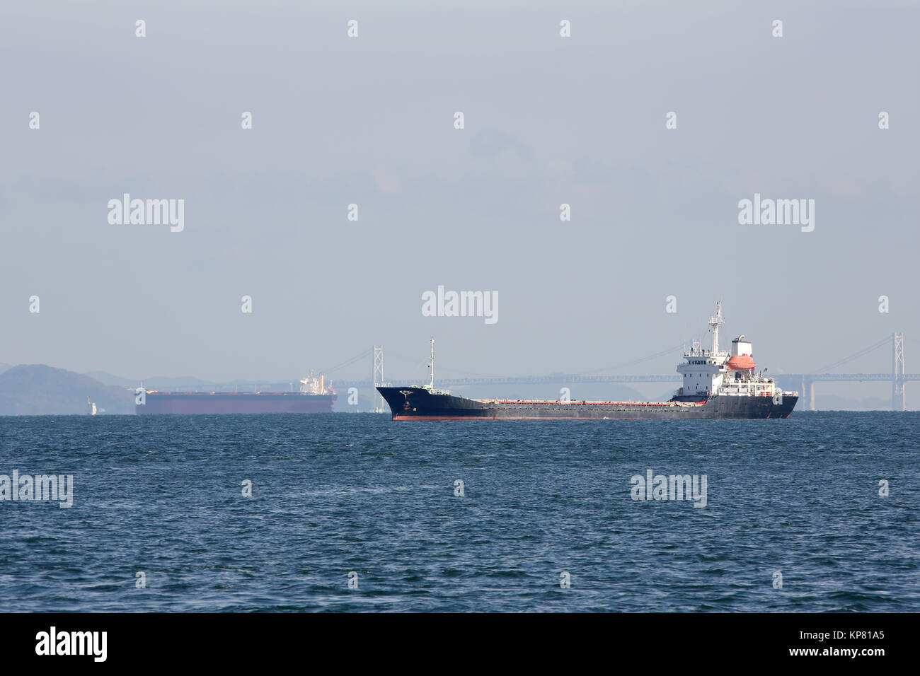 large cargo freighter ship against blue sky Stock Photo - Alamy