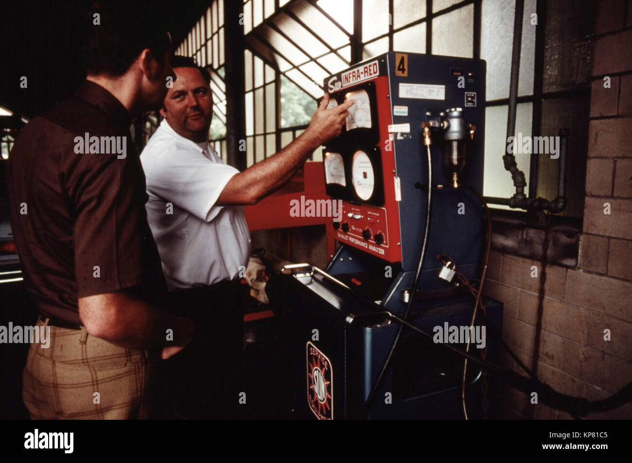 Employee at an auto emission inspection station in downtown cincinnati ...