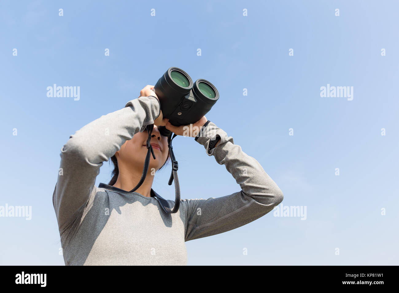 Woman use of the binocular Stock Photo - Alamy