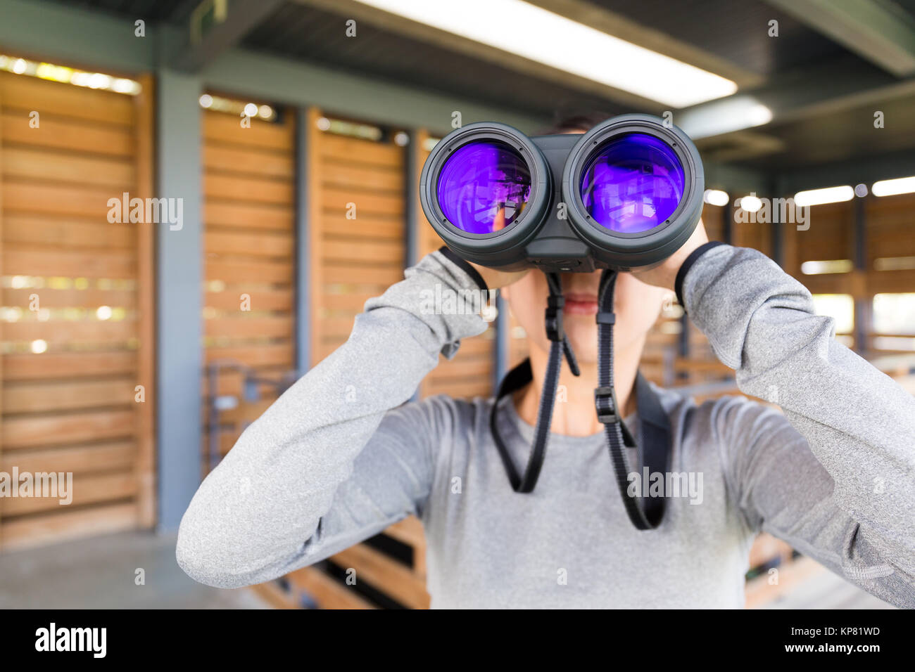 Young woman use of the binoculars at wooden house Stock Photo - Alamy