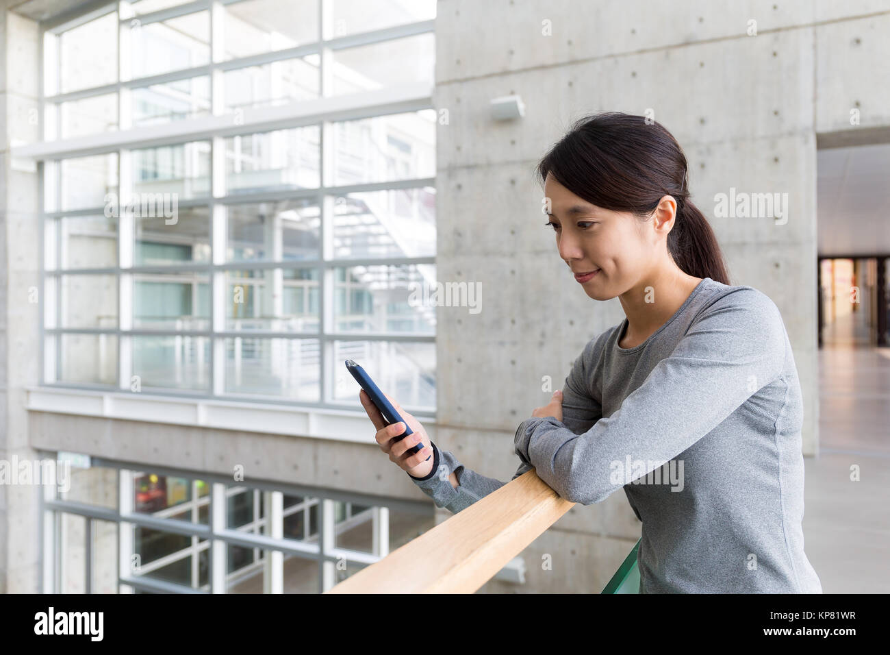Woman read on the cellphone at indoor Stock Photo - Alamy