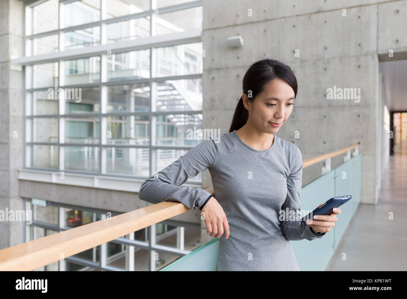 Woman checking something on cellphone at indoor Stock Photo - Alamy