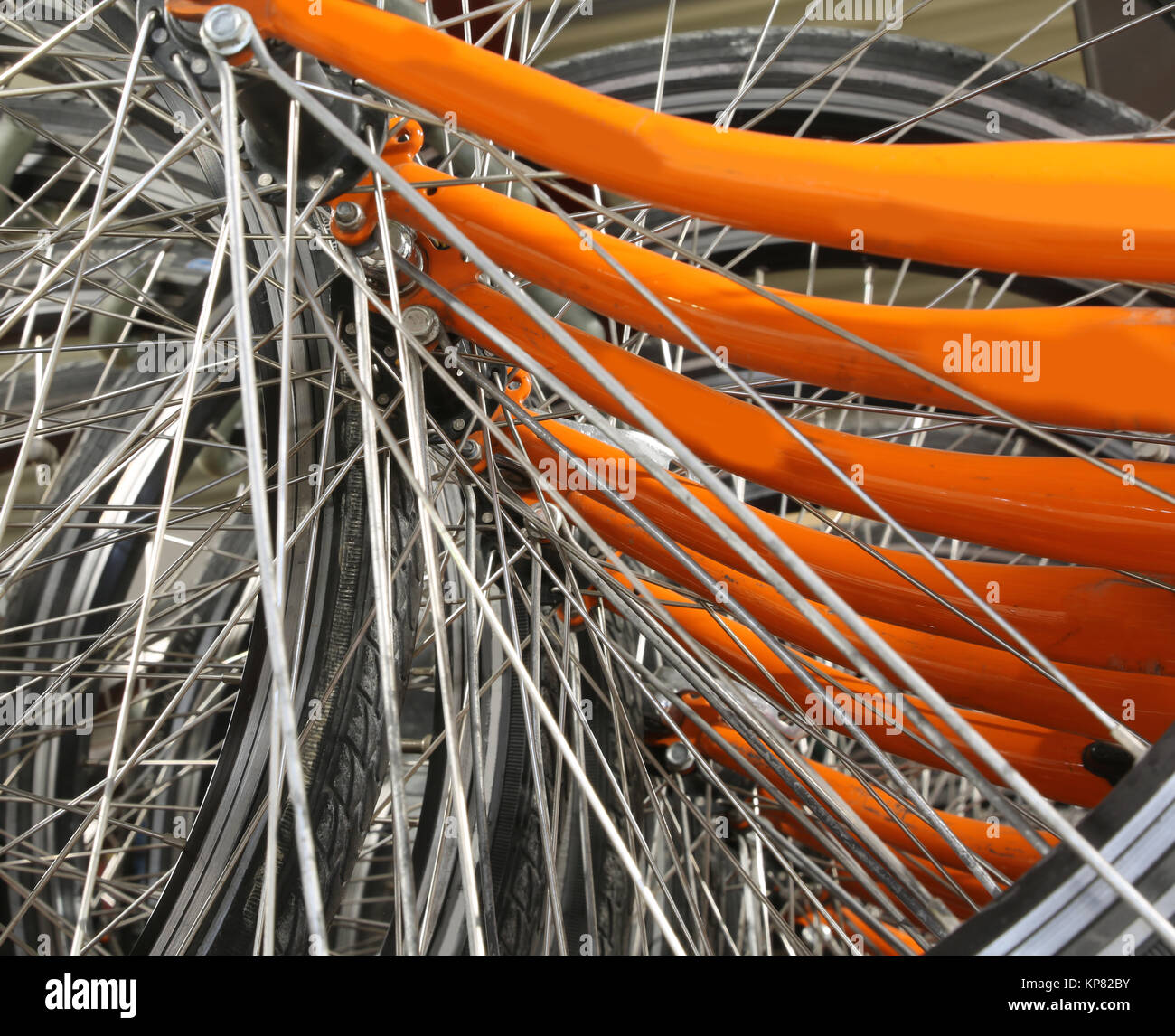 background with many metallic spokes of orange bicycle Stock Photo - Alamy