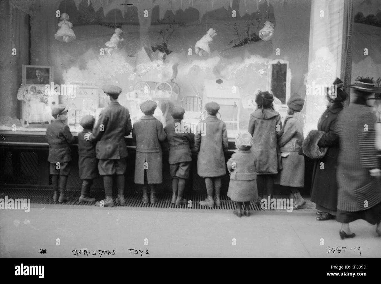 Children looking into store window along a New York City street with ...