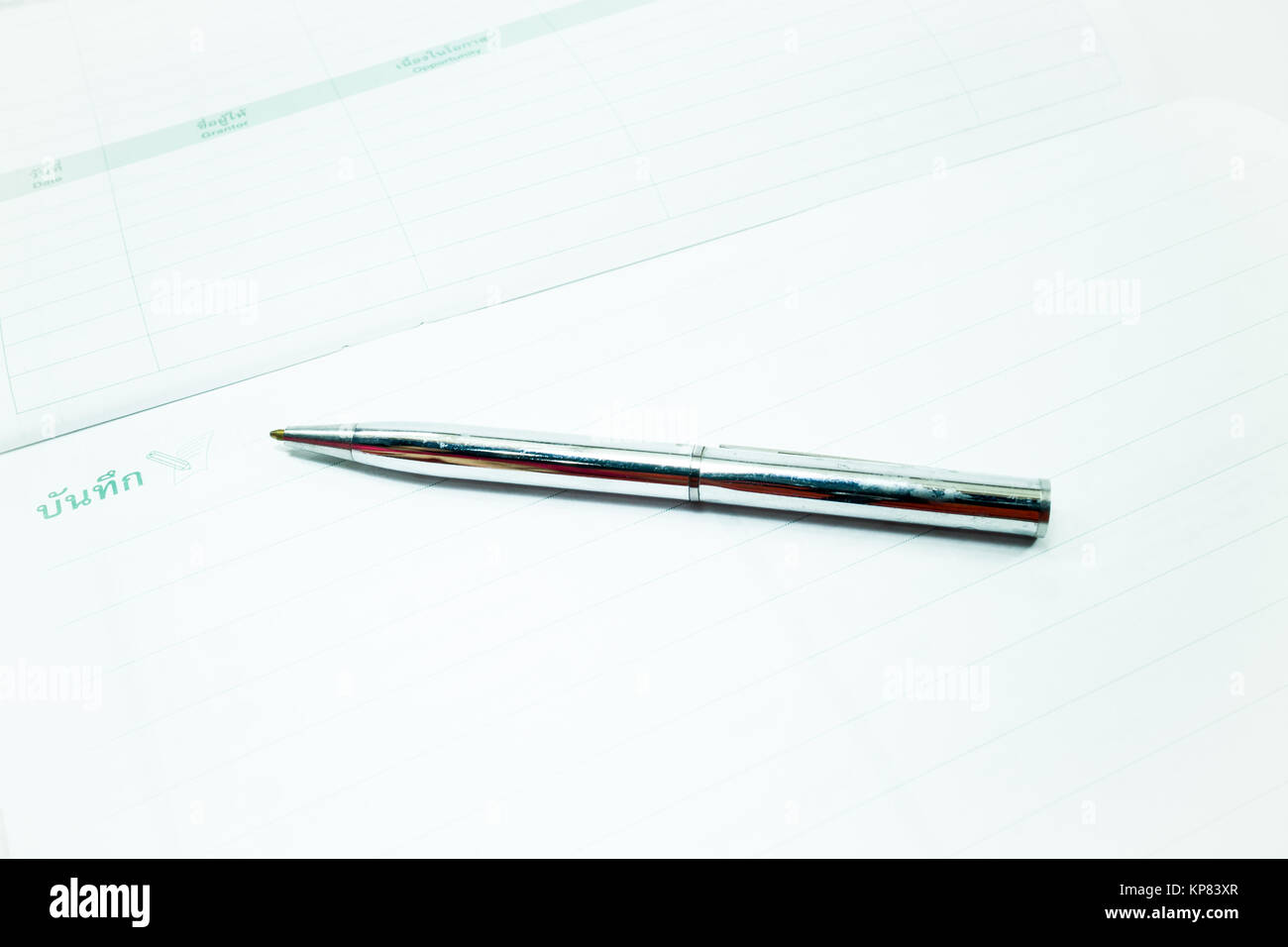 Metallic pen and recording paper Stock Photo - Alamy