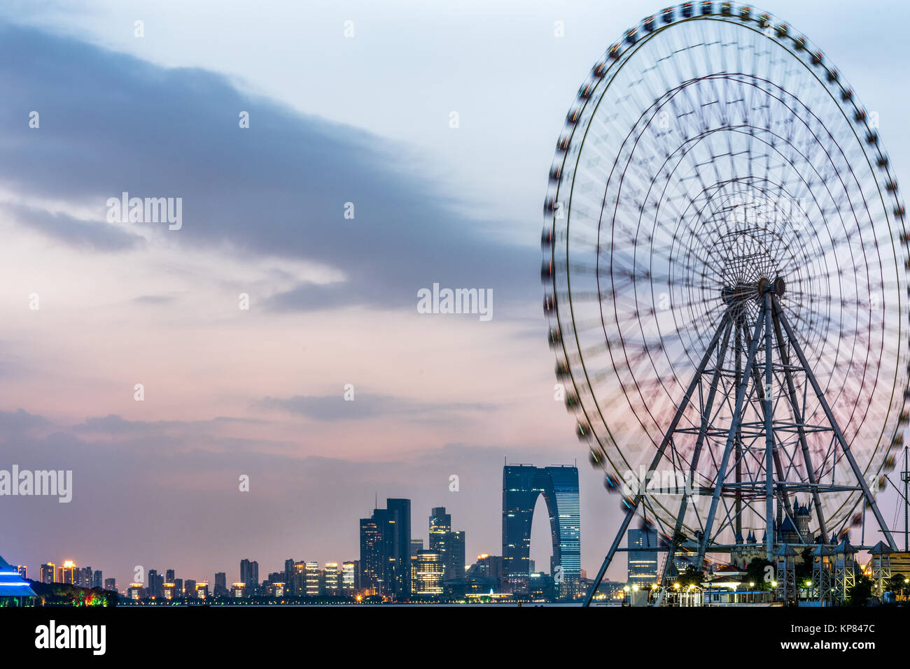 ferris wheel with cityscape in background in Suzhou,China Stock Photo ...