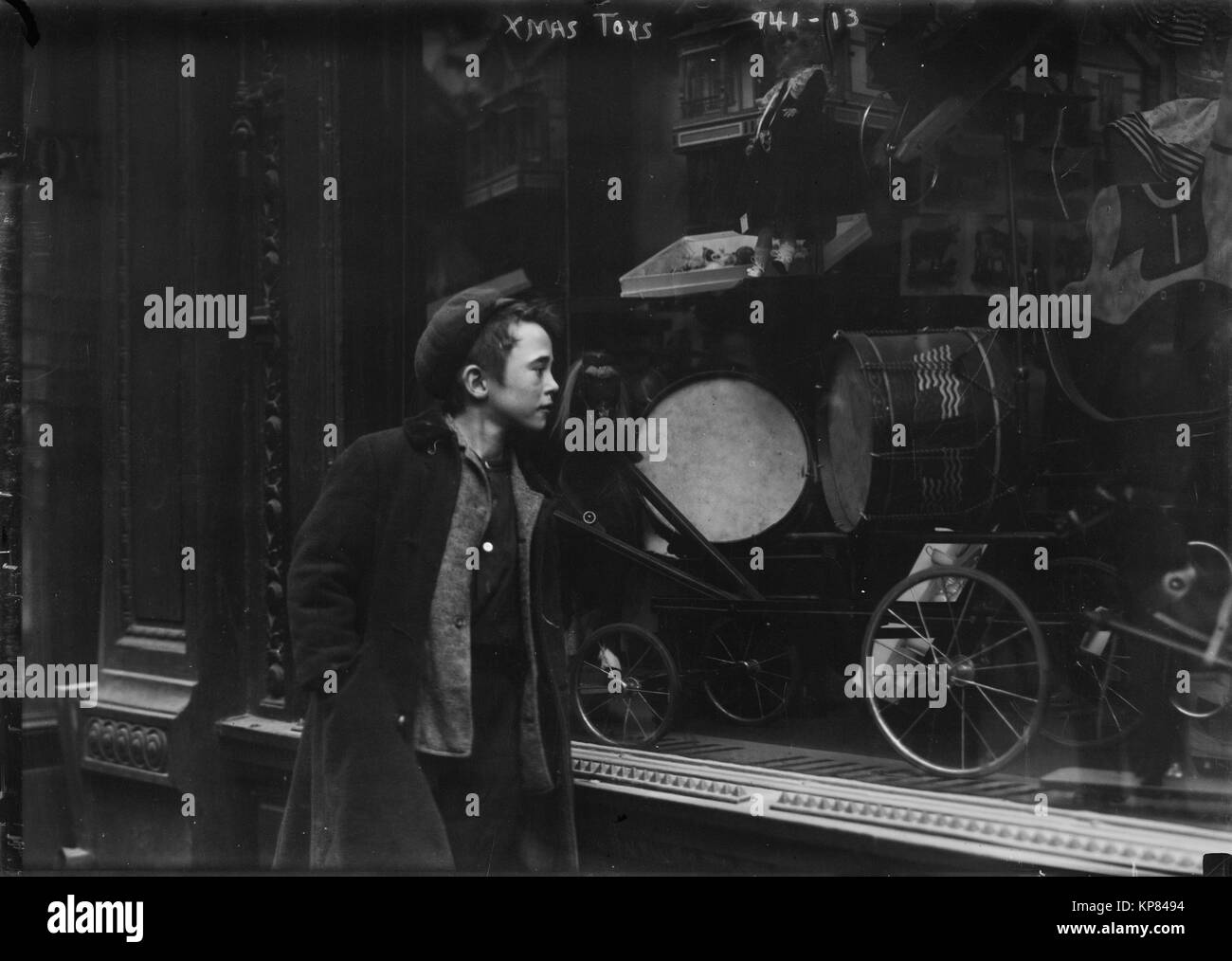 Poor boy early 20th century 1910s looking at store window display in ...