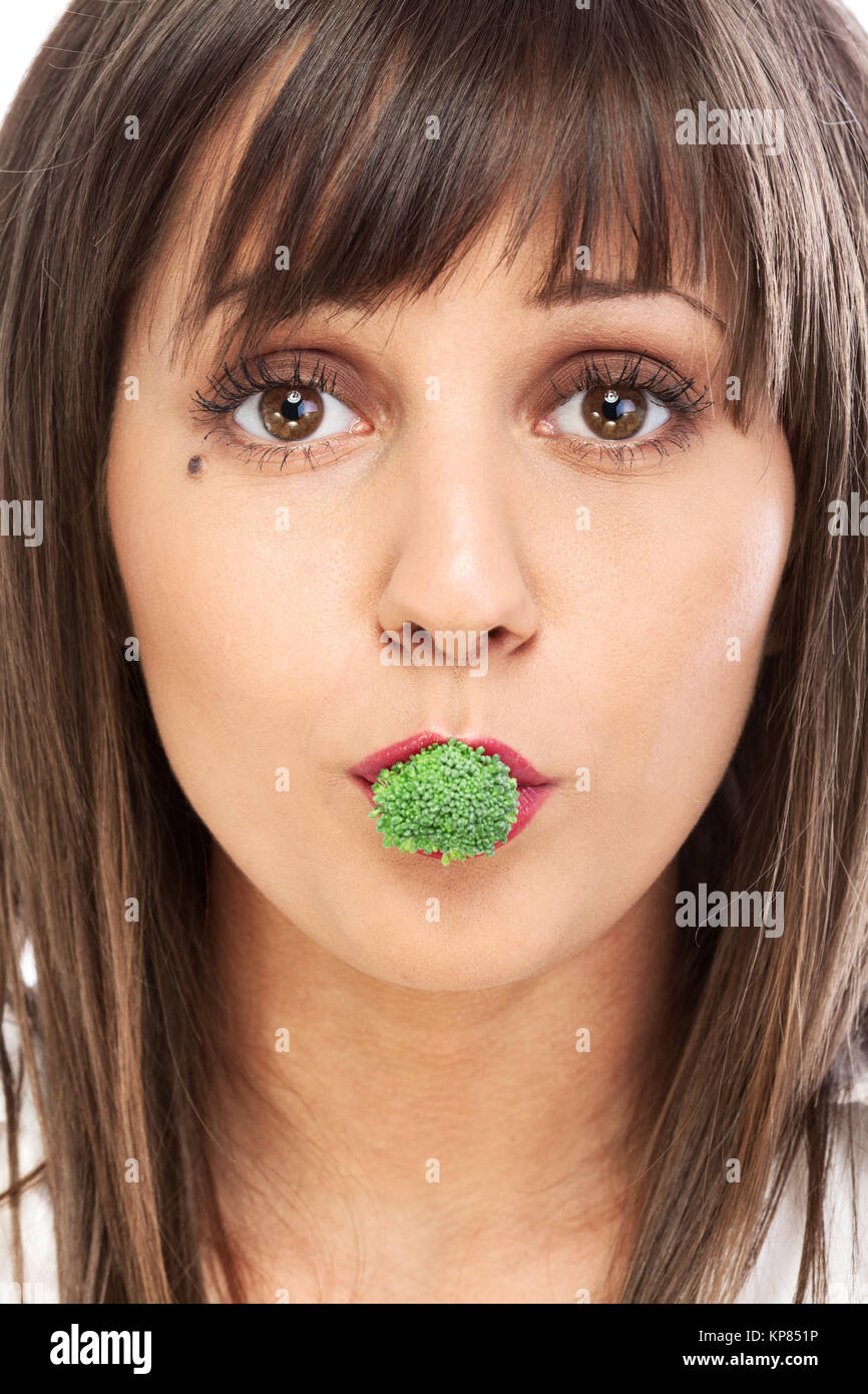 Young woman eating broccoli Stock Photo - Alamy