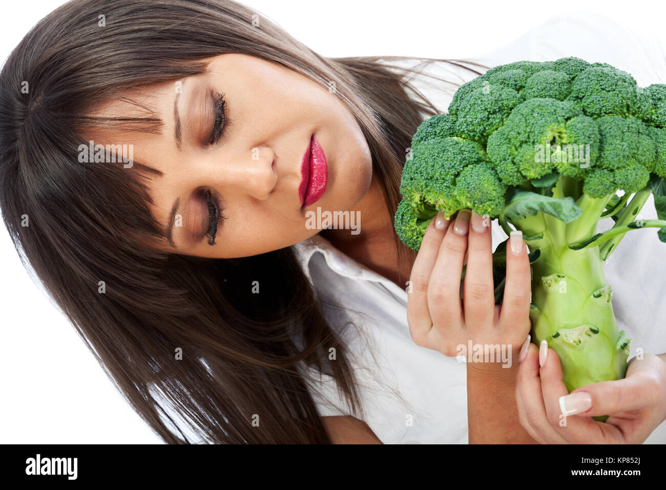 Young woman holding broccoli Stock Photo - Alamy