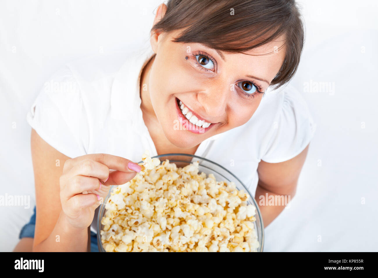 Young woman eating popcorn,Young woman eating popcorn,Young woman ...