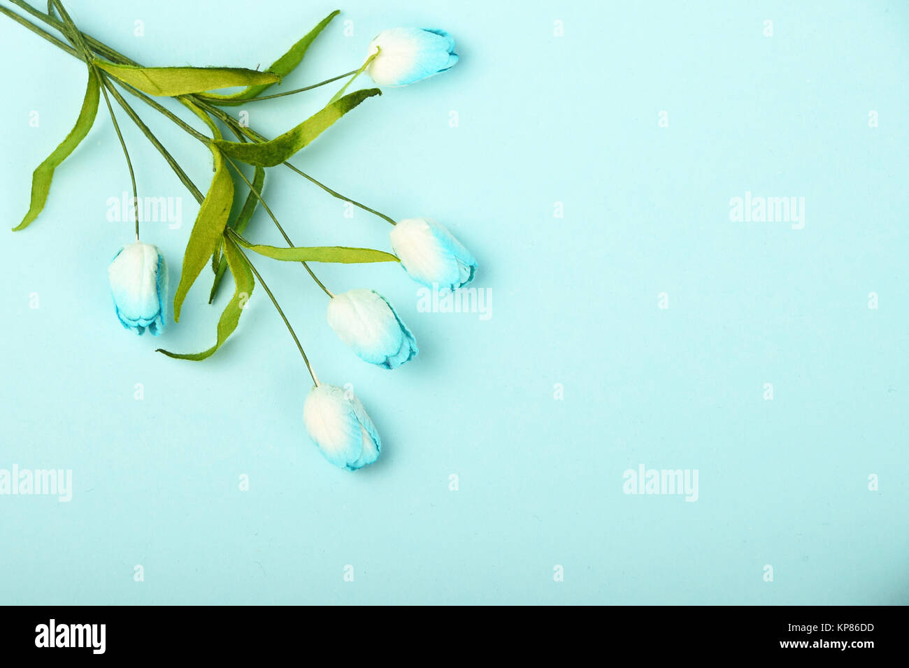 One mulberry paper flowers bouquet on blue background Stock Photo - Alamy