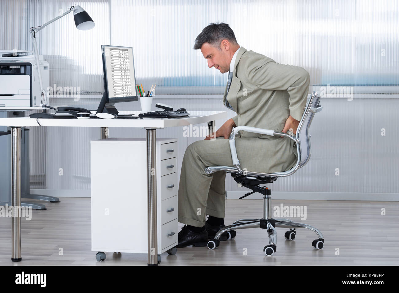 Accountant Suffering From Back Pain At Desk Stock Photo - Alamy