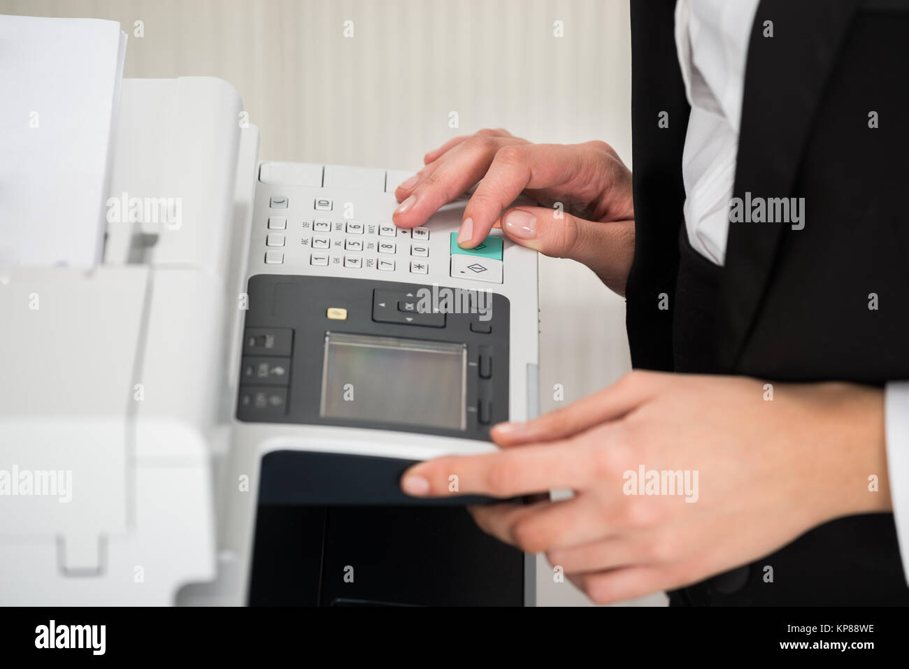 Businesswoman Operating Printer In Office Stock Photo - Alamy