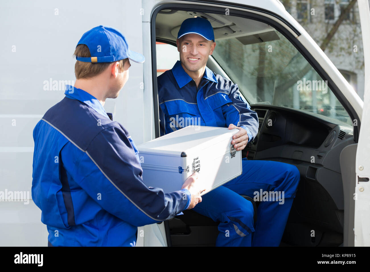 Happy Technician Giving Toolbox To Colleague Stock Photo - Alamy